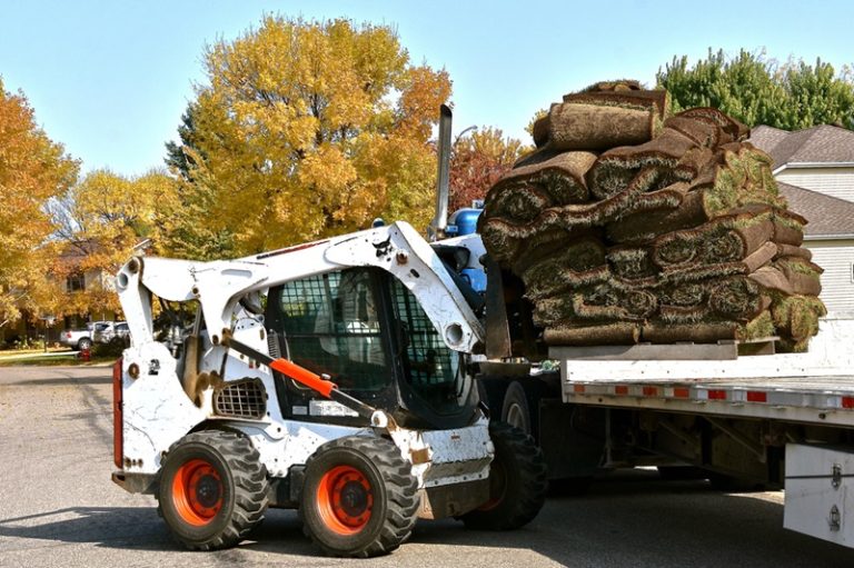 Skid Steer Lifting a Loaded Pallet | Steel Sheds in Australia